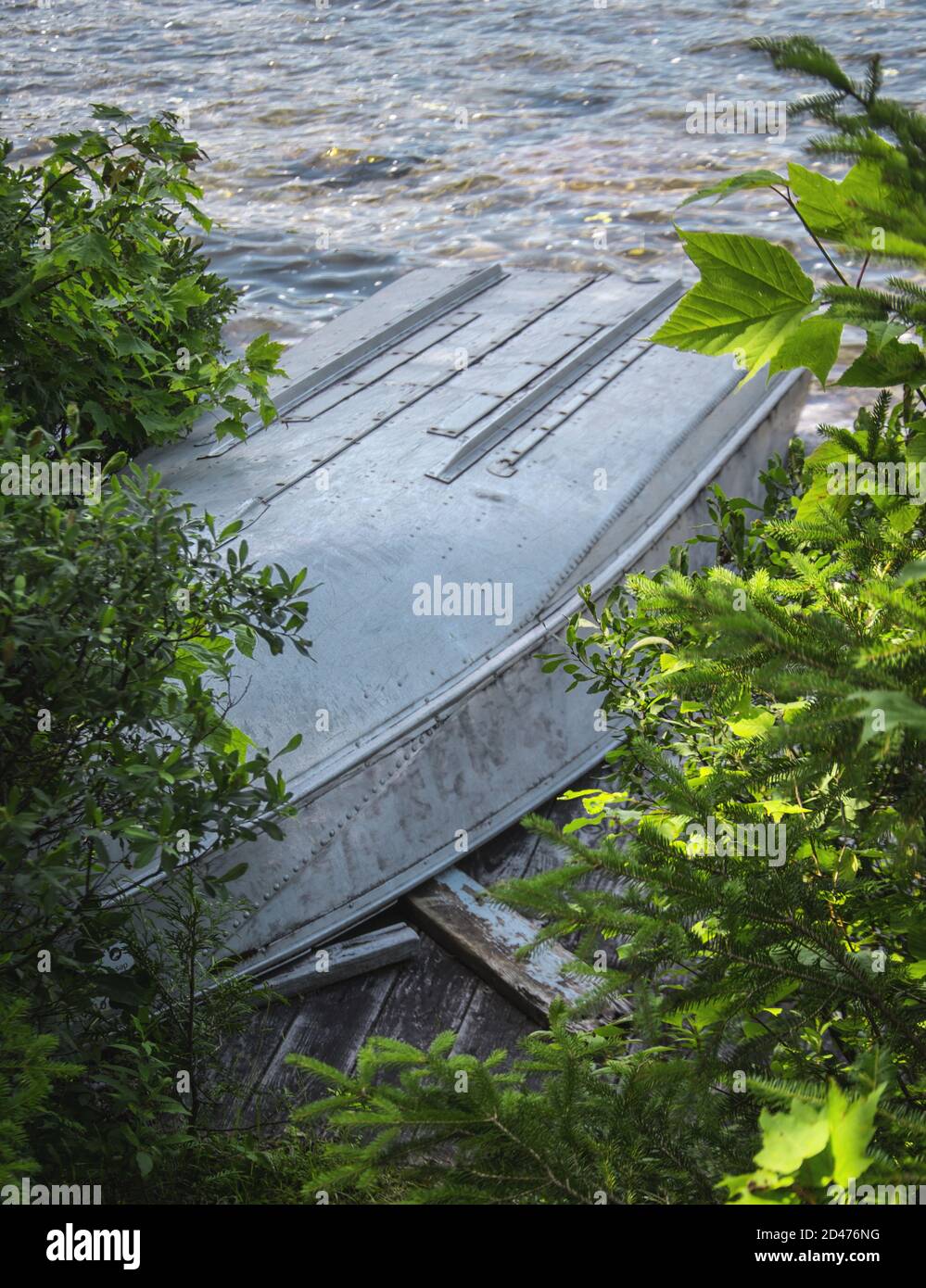 Vertical high angle shot of an upside-down rowboat on a dock Stock ...