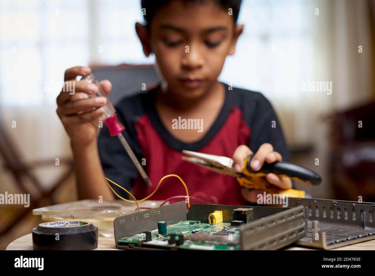 Asian Schoolboy studying electronic at home Stock Photo - Alamy