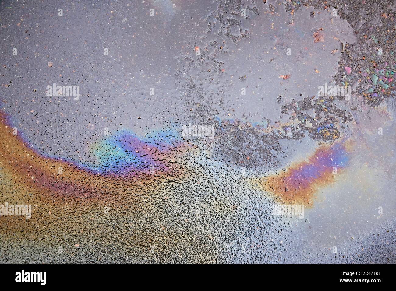 Color gasoline fuel spot on black asphalt, industrial pollution concept ...