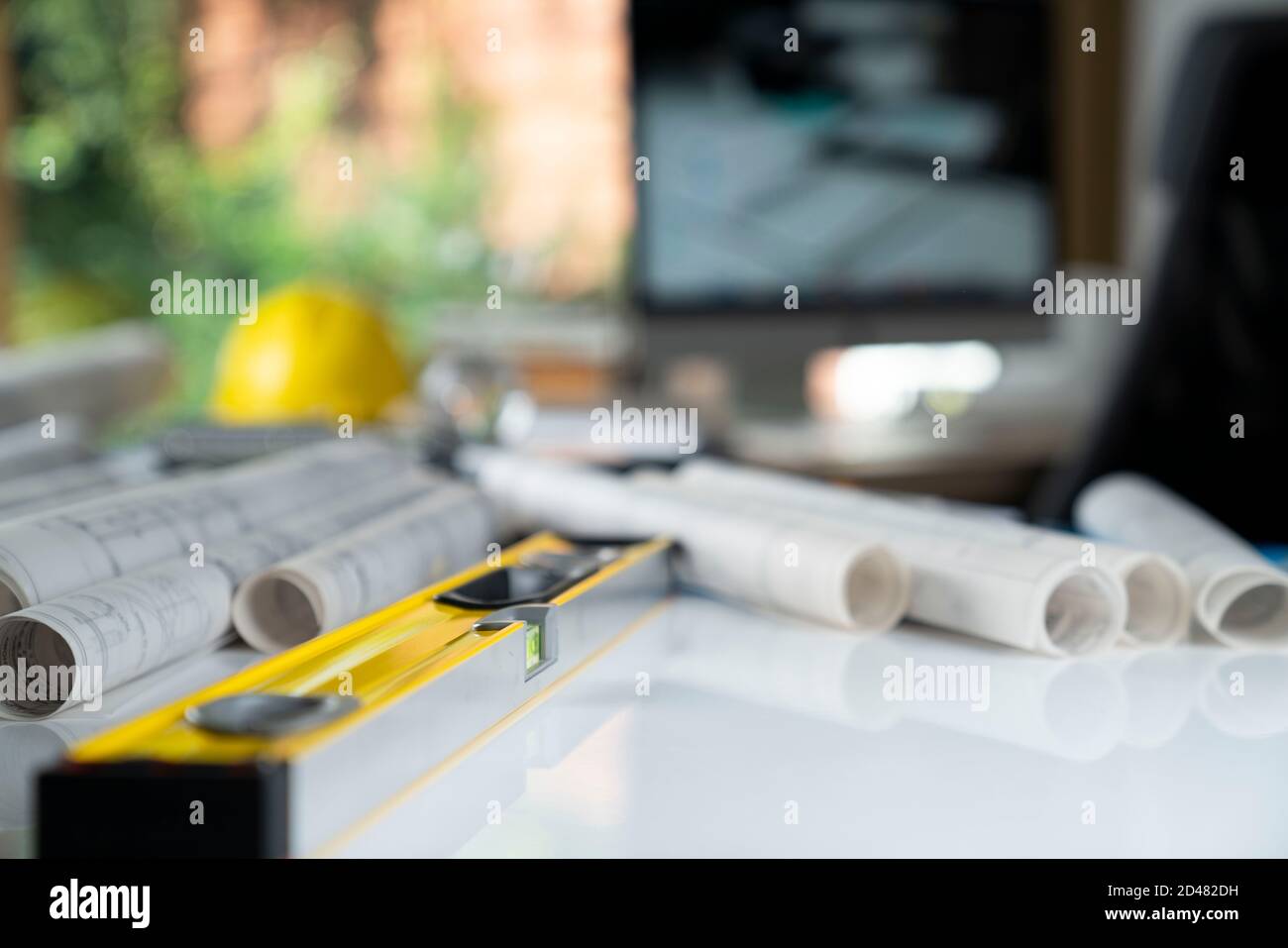 Contractor office. Tool kit of the contractor: yellow hardhat, libella ...