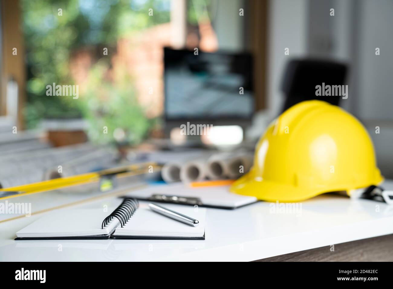 Contractor office. Tool kit of the contractor: yellow hardhat, libella ...