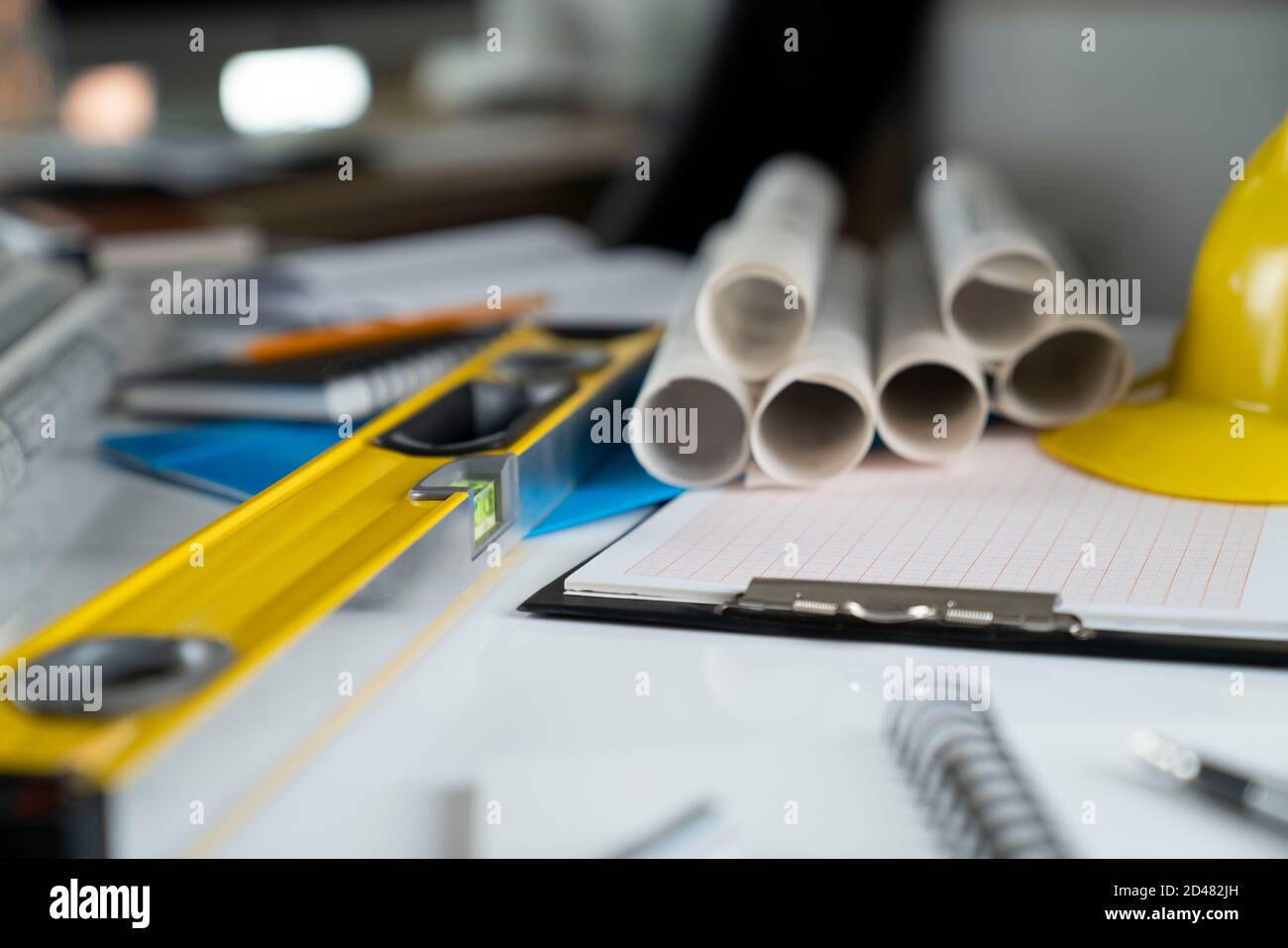 Contractor office. Tool kit of the contractor: yellow hardhat, libella ...