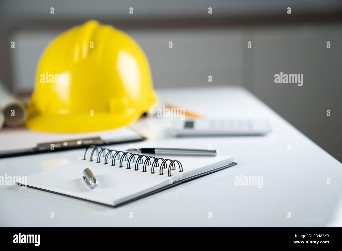 Contractor office. Tool kit of the contractor: yellow hardhat, libella ...