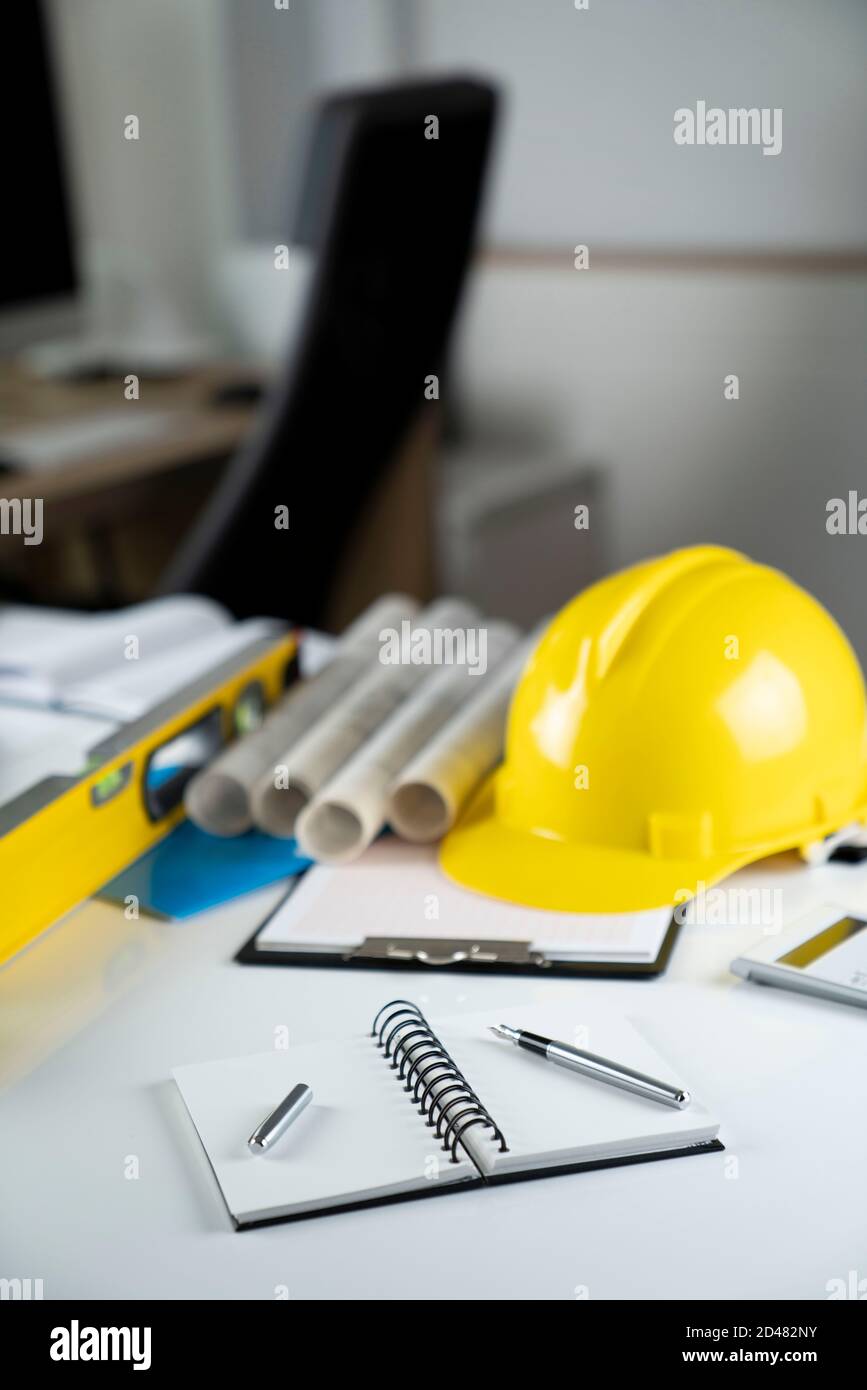 Contractor office. Tool kit of the contractor: yellow hardhat, libella ...