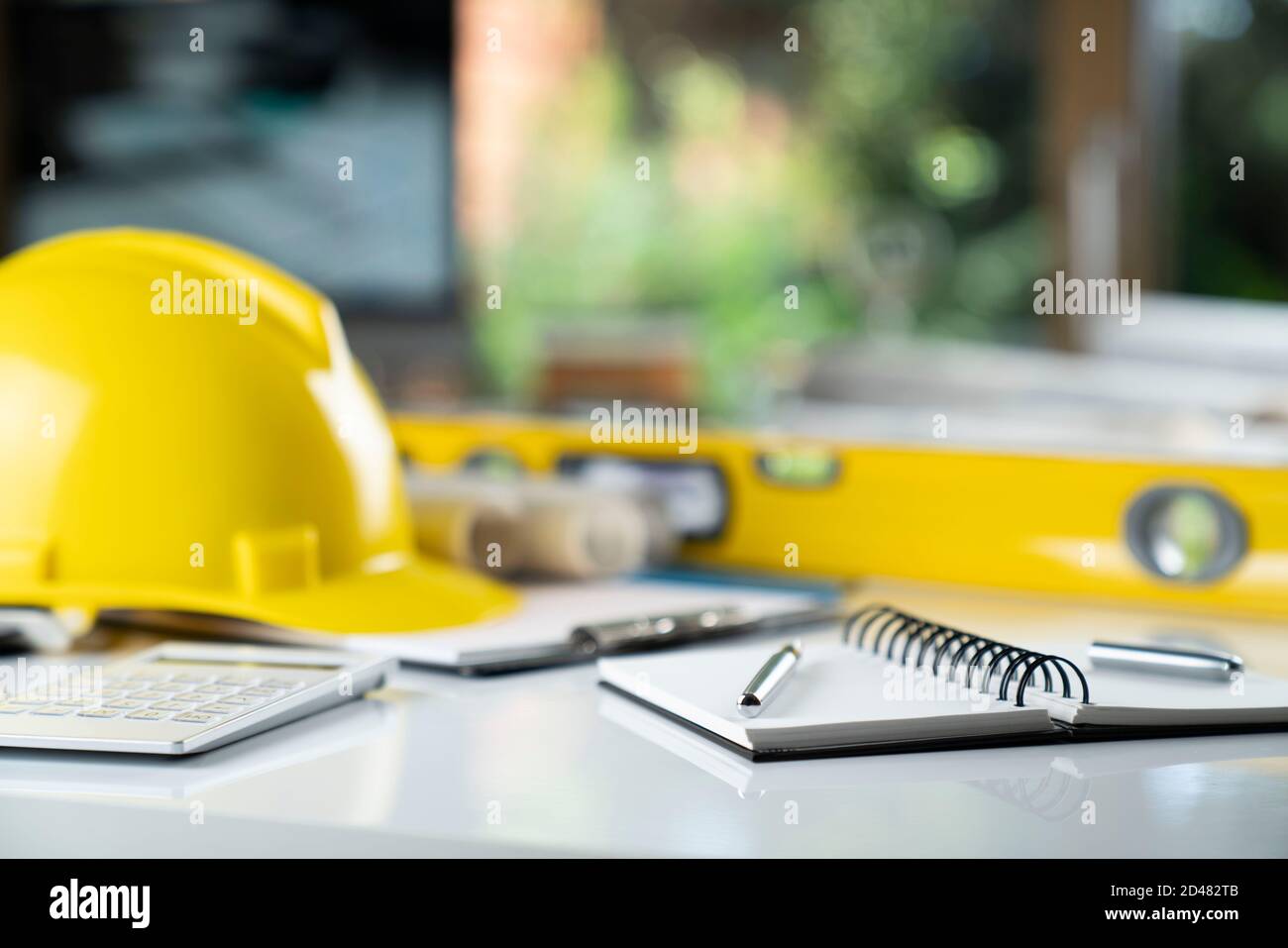 Contractor office. Tool kit of the contractor: yellow hardhat, libella ...