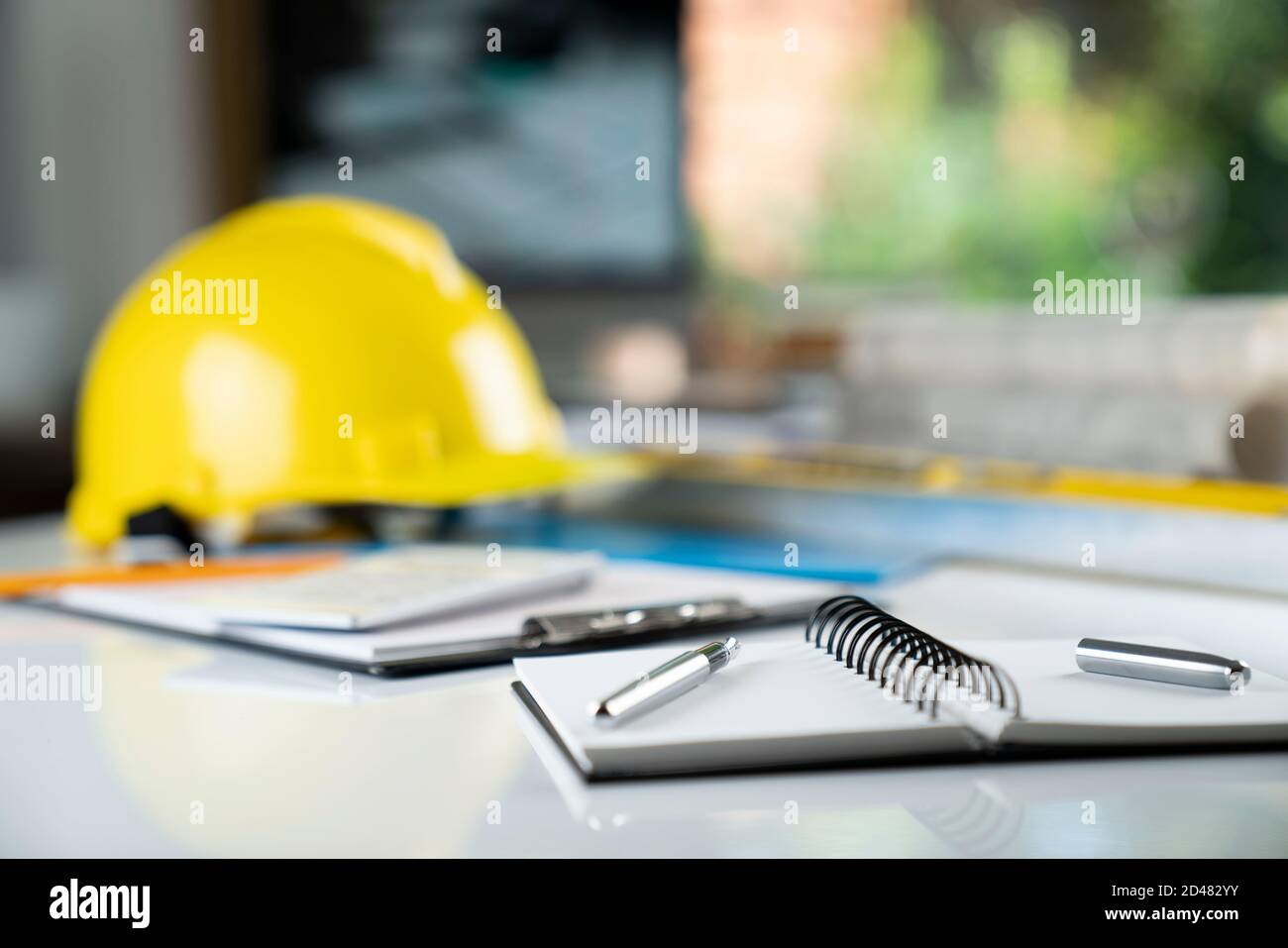 Contractor office. Tool kit of the contractor: yellow hardhat, libella ...