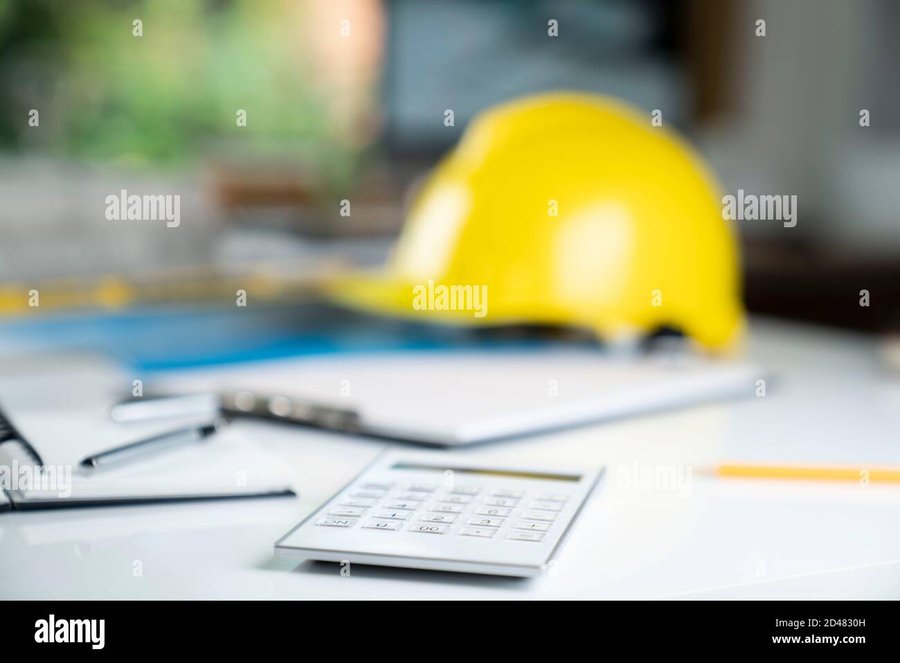 Contractor office. Tool kit of the contractor: yellow hardhat, libella ...
