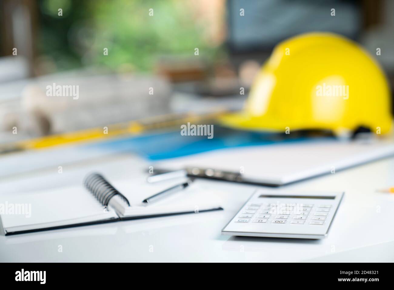 Contractor office. Tool kit of the contractor: yellow hardhat, libella ...