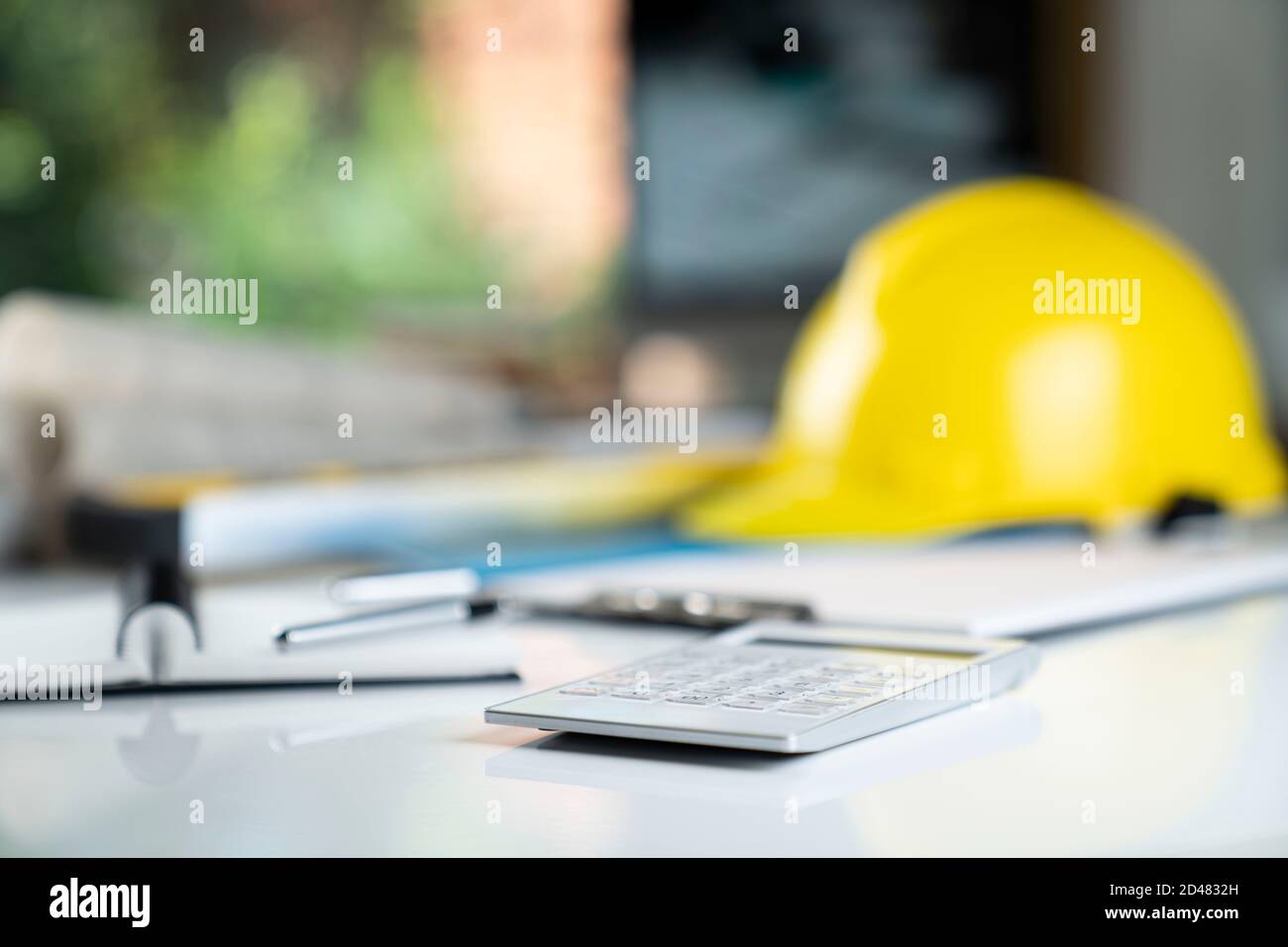 Contractor office. Tool kit of the contractor: yellow hardhat, libella ...
