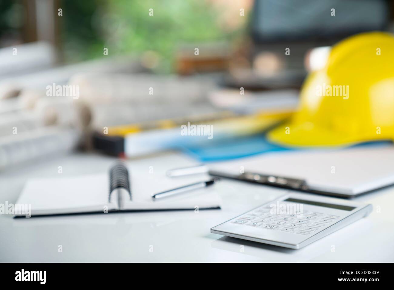 Contractor office. Tool kit of the contractor: yellow hardhat, libella ...