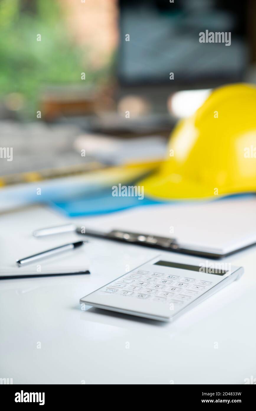 Contractor office. Tool kit of the contractor: yellow hardhat, libella ...