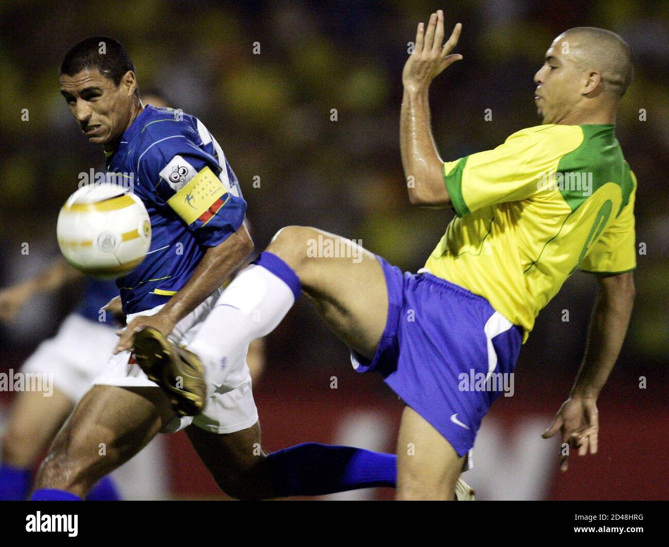 Brazilian soccer star Ronaldo (R) clears the ball away from Colombia's ...
