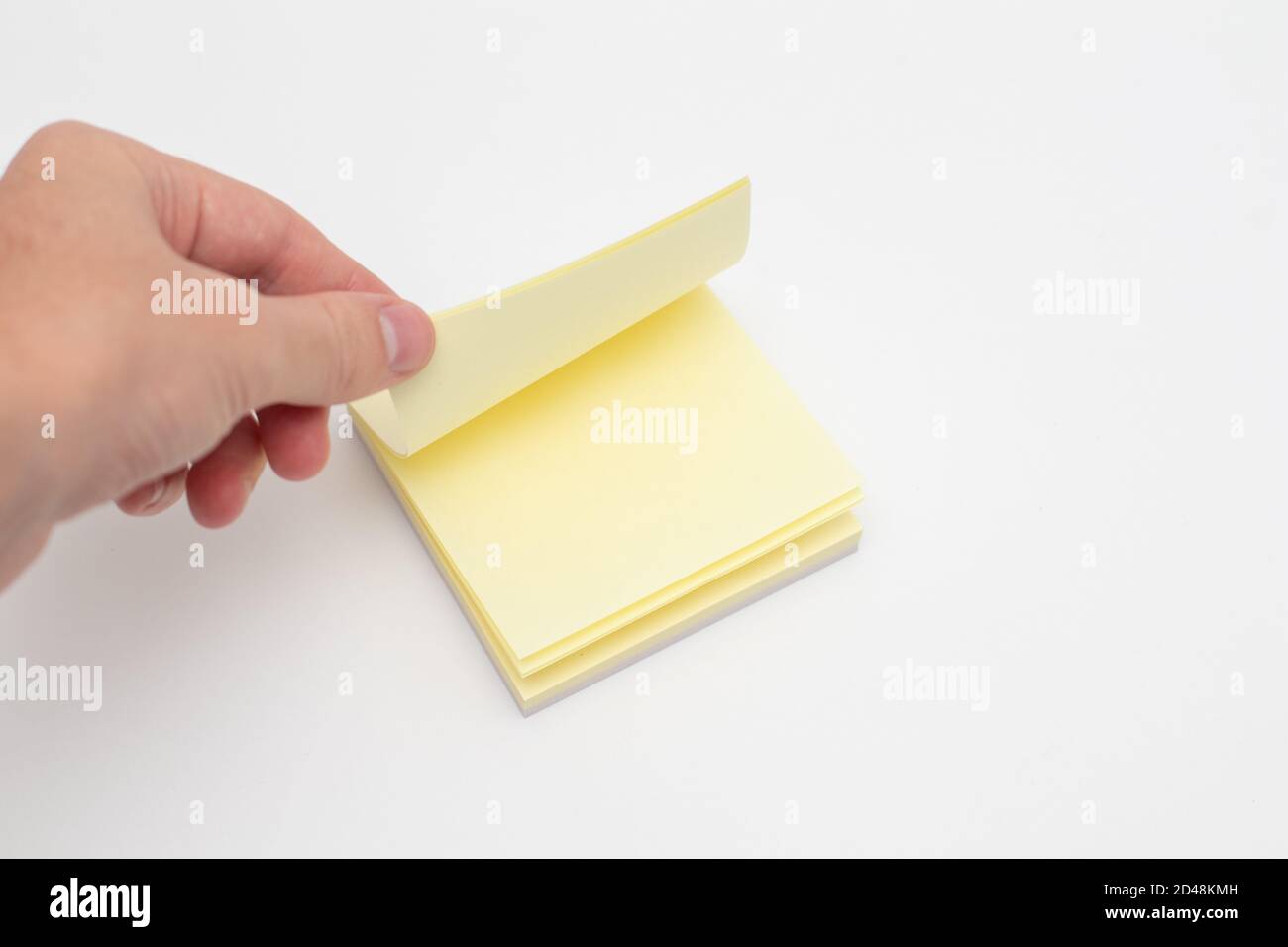 Hand takes a sticker from a stack of colored stickers Stock Photo - Alamy