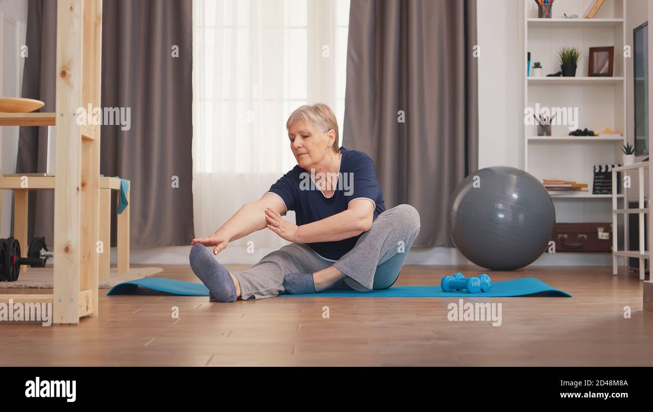 Old woman stretching hi-res stock photography and images - Alamy