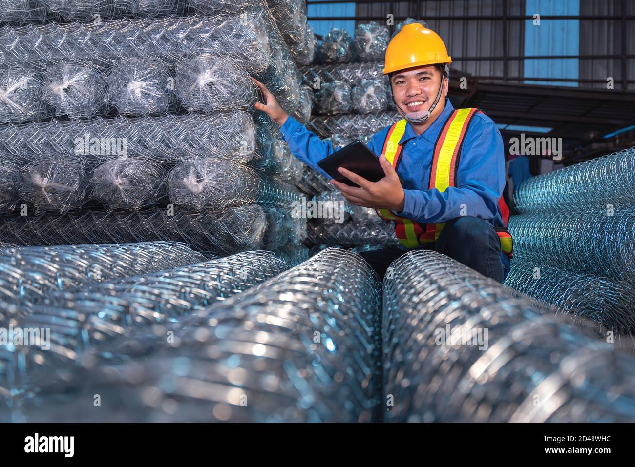 Cargo Inspection worker Rolls of steel wire mesh for construction work ...