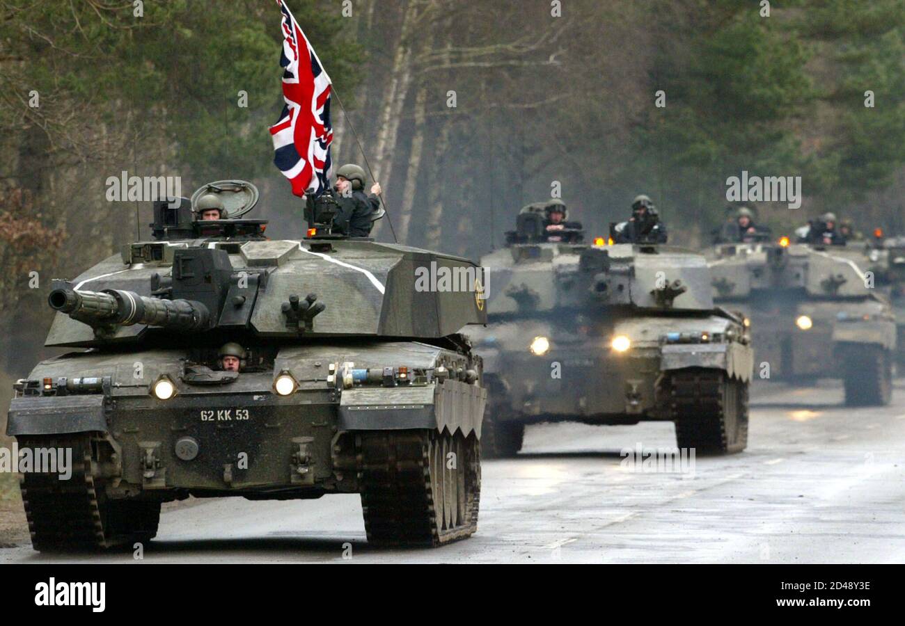 A convoy of Challenger Two tanks drive along a road during media day at ...