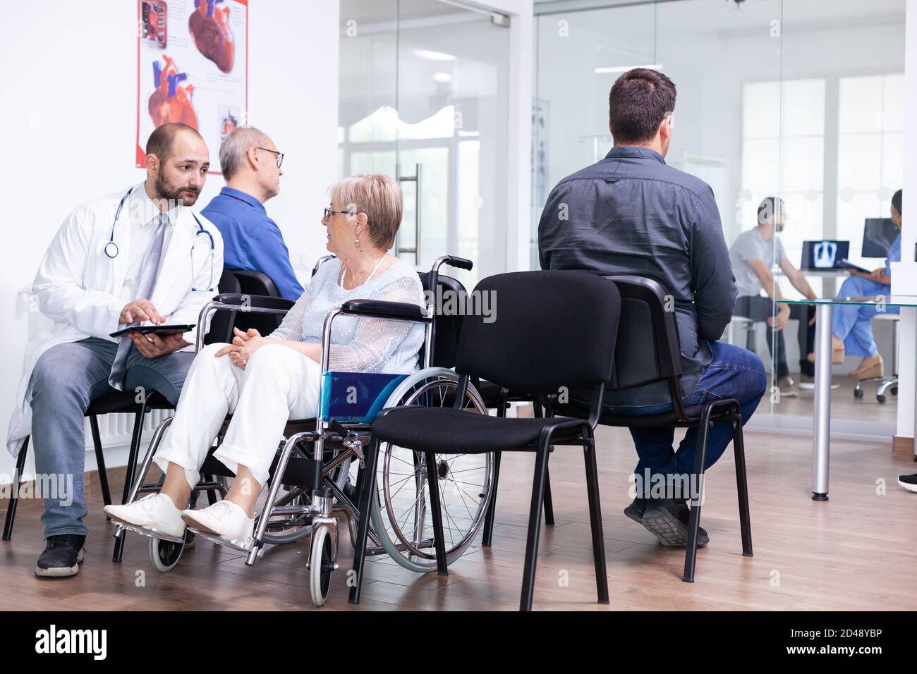 Doctor holding tablet pc with x-ray while explaining diagnosis to ...