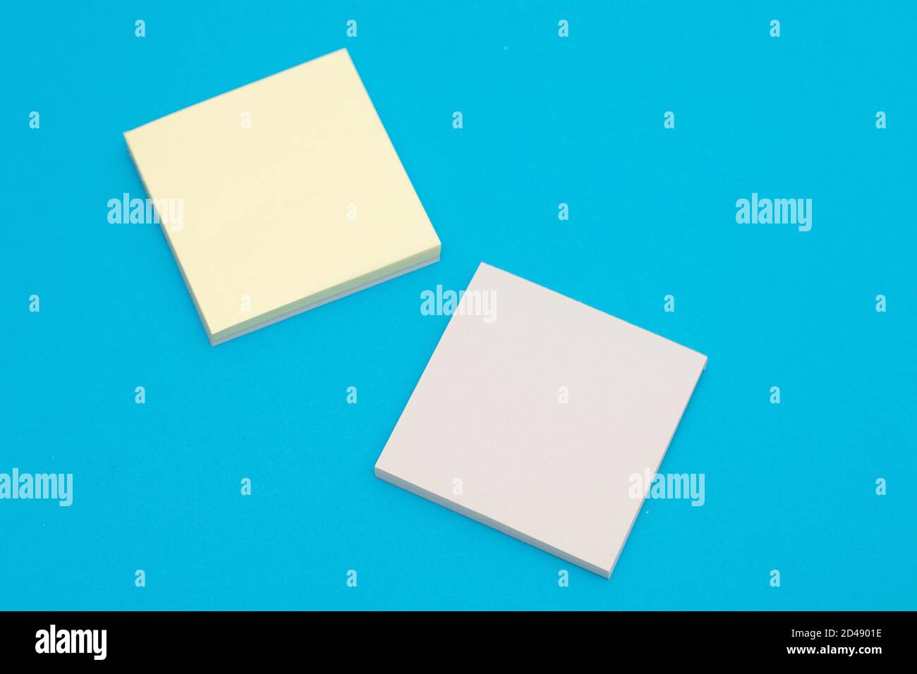 Stack of yellow paper stickers on blue background Stock Photo - Alamy