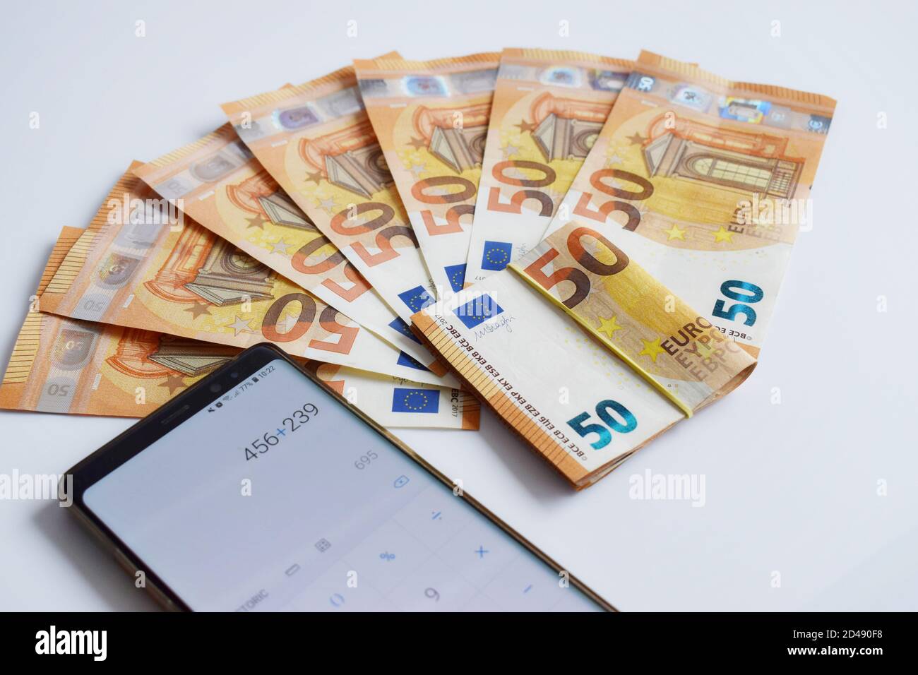 Finance concept, smart phone with euro banknotes, isolated on white ...