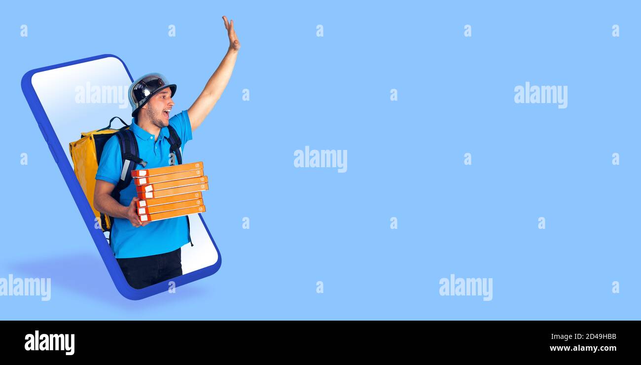 Pizza party. Handsome delivery man giving order right from smartphone's ...