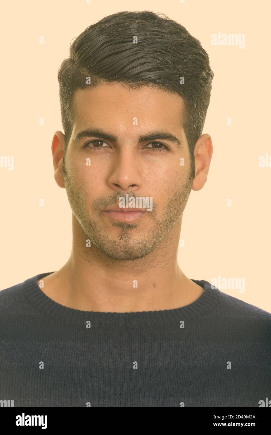 Face of young handsome Persian man looking at camera Stock Photo - Alamy