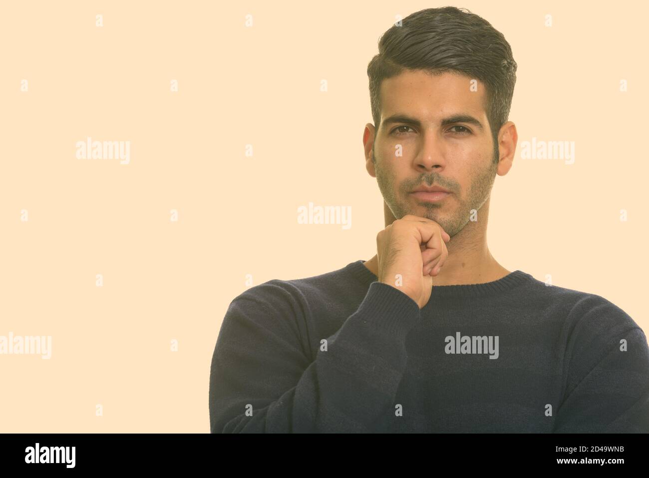 Portrait of young handsome Persian man thinking Stock Photo - Alamy