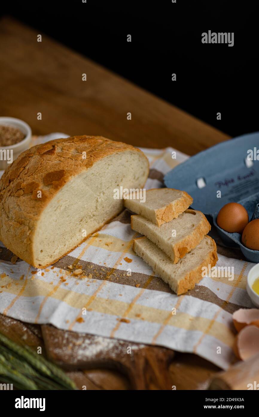 Fresh bread placed on a towel together with tomatoes and eggs. Bakery ...