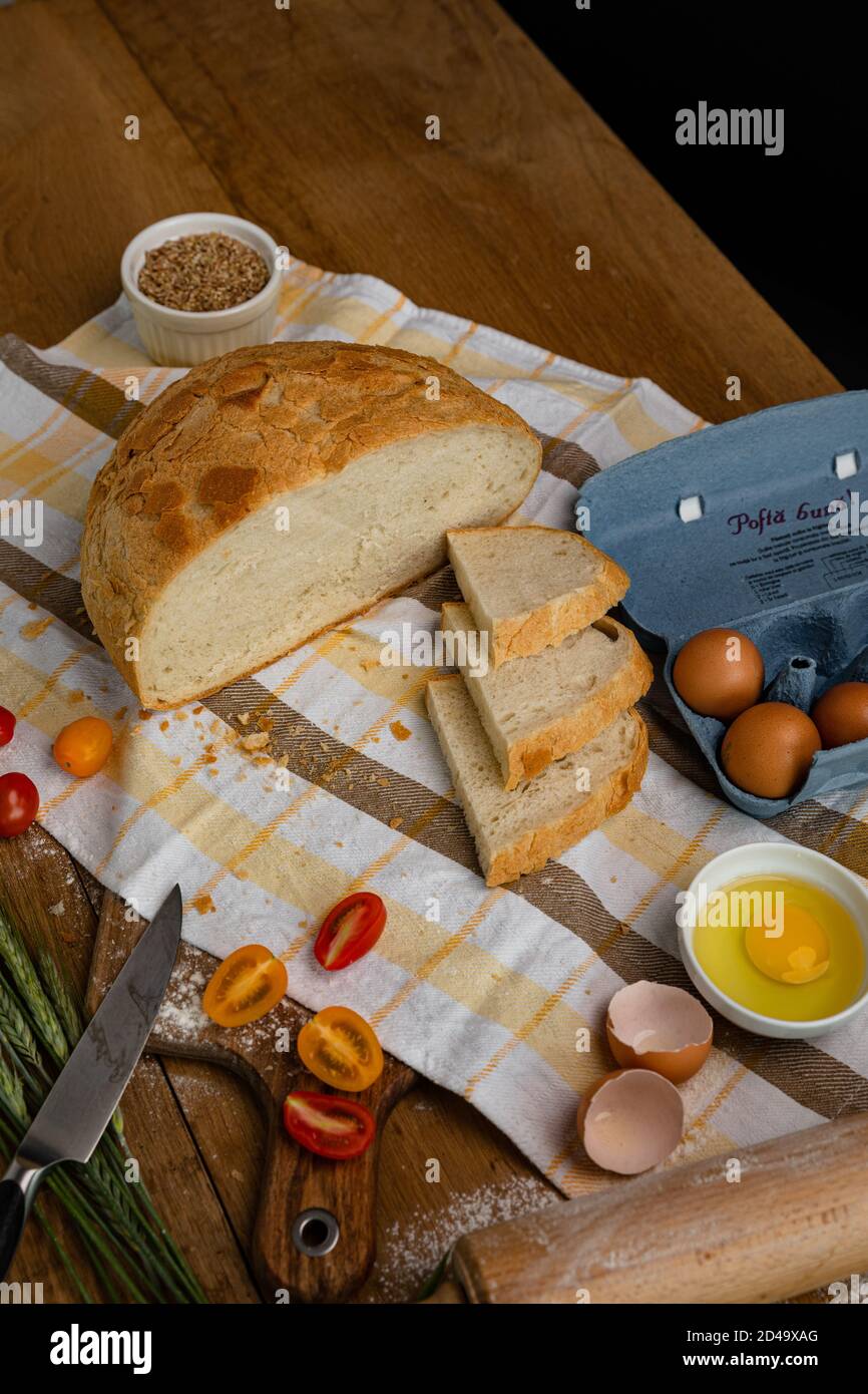 Fresh bread placed on a towel together with tomatoes and eggs. Bakery ...