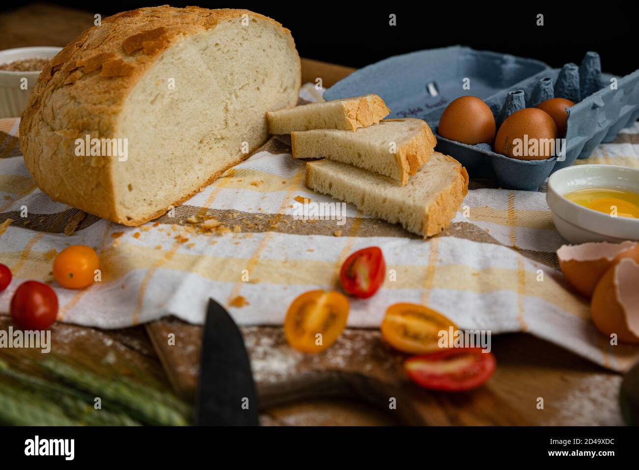 Fresh bread placed on a towel together with tomatoes and eggs. Bakery ...