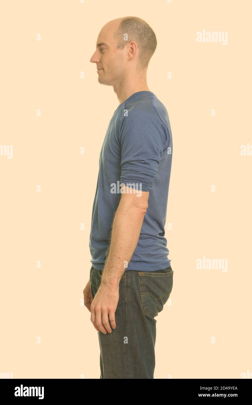 Profile view of handsome bald man against white background Stock Photo ...