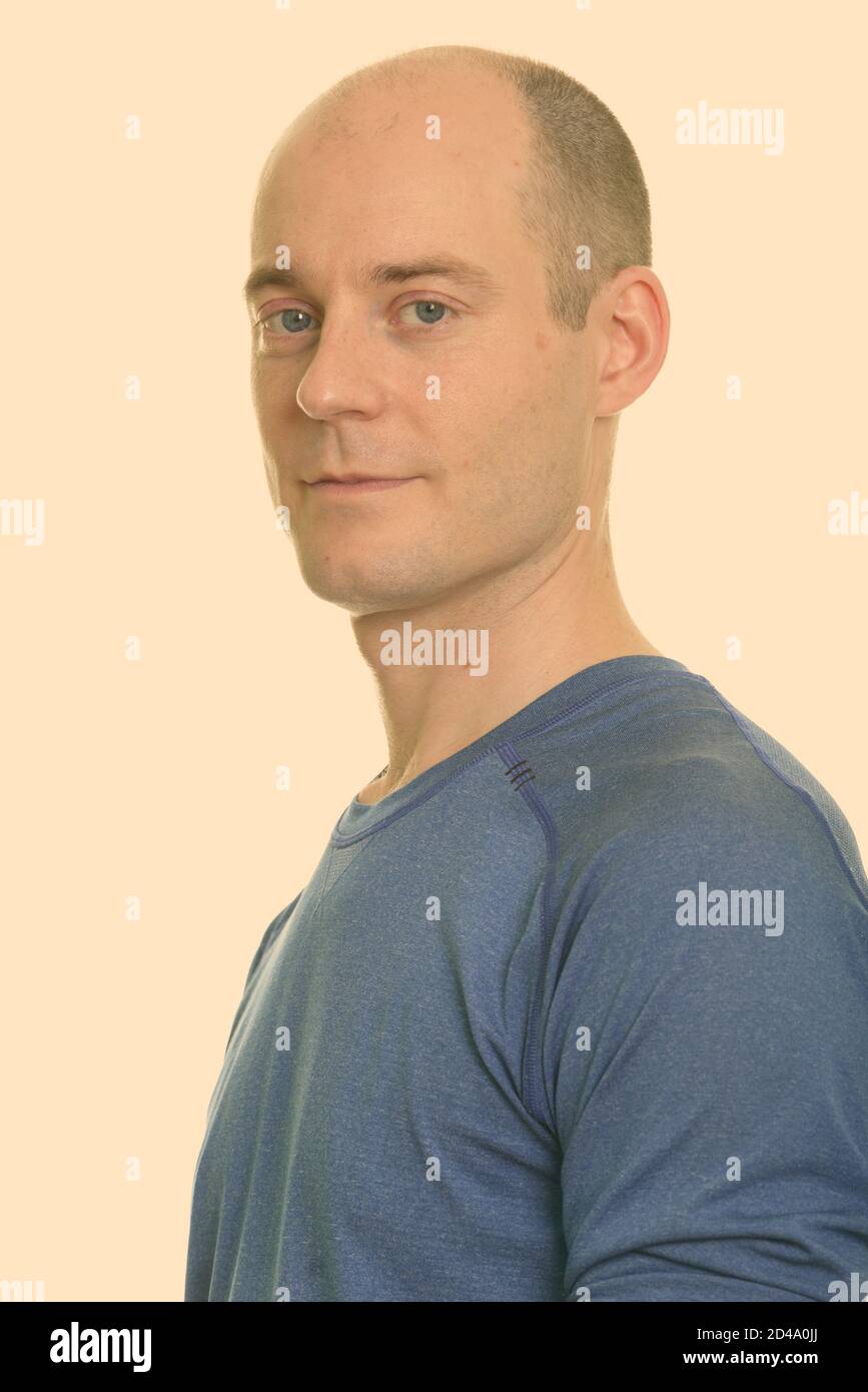 Profile view of handsome bald man looking at camera Stock Photo - Alamy