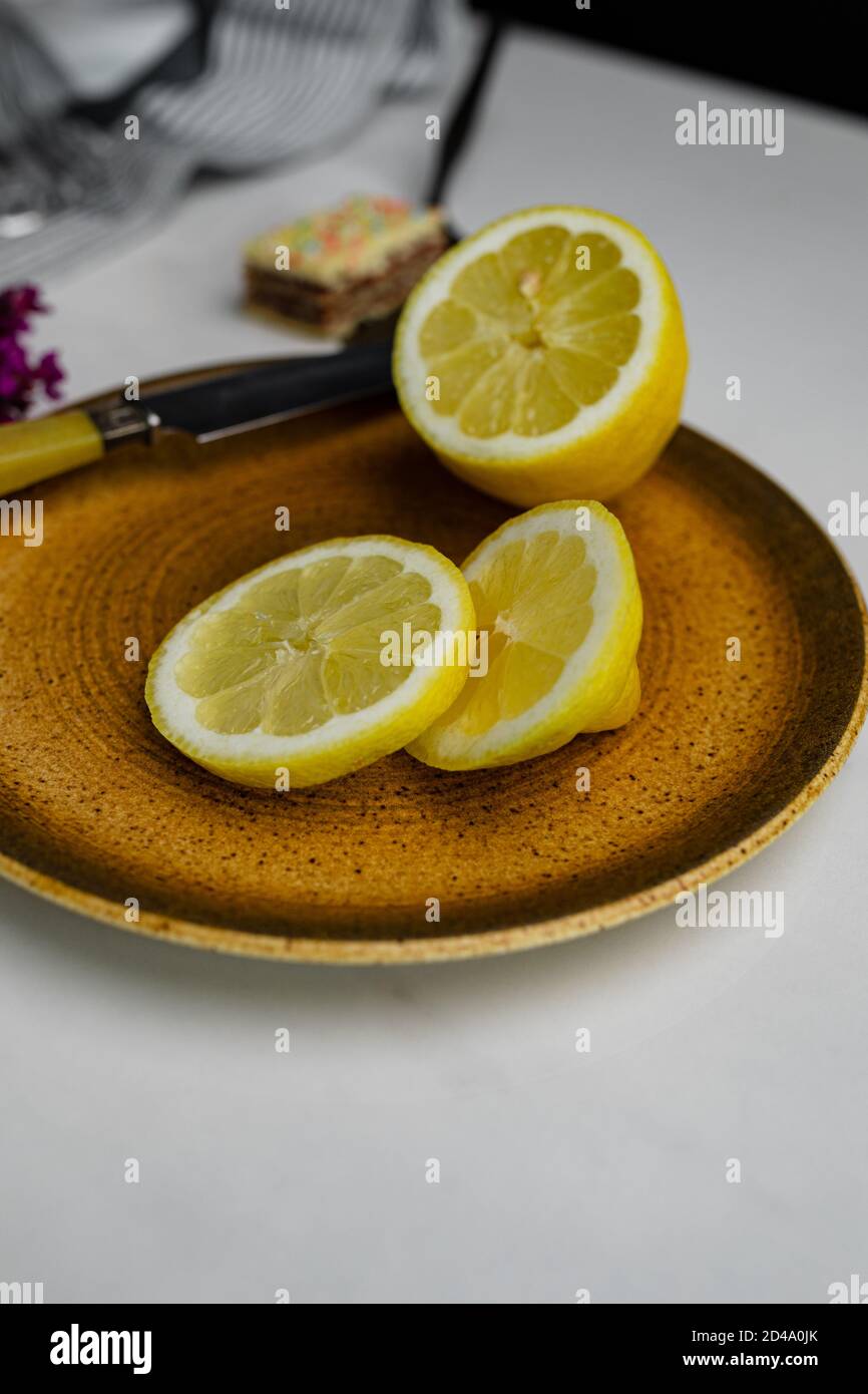 Lemon slices cut on a ceramic plate Stock Photo - Alamy