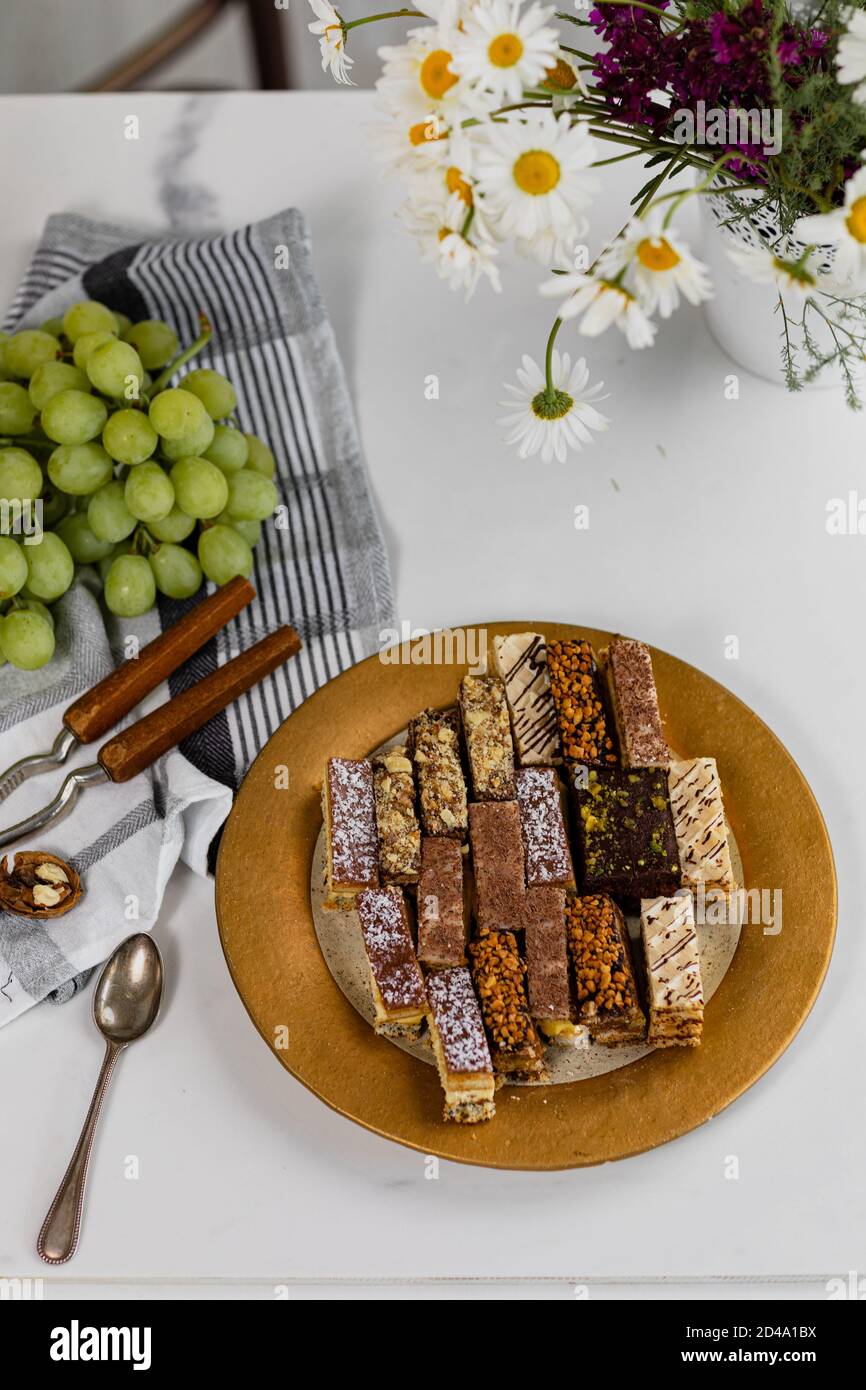 Assorted homemade cakes stage with grapes and nuts. Top view, flat lay ...