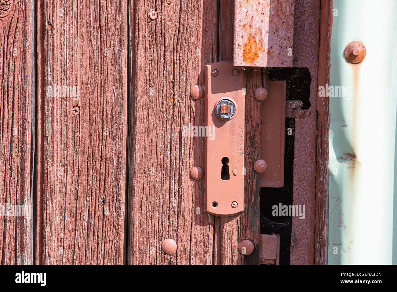 Close-up of an old door with weathered planks and a broken lock Stock ...