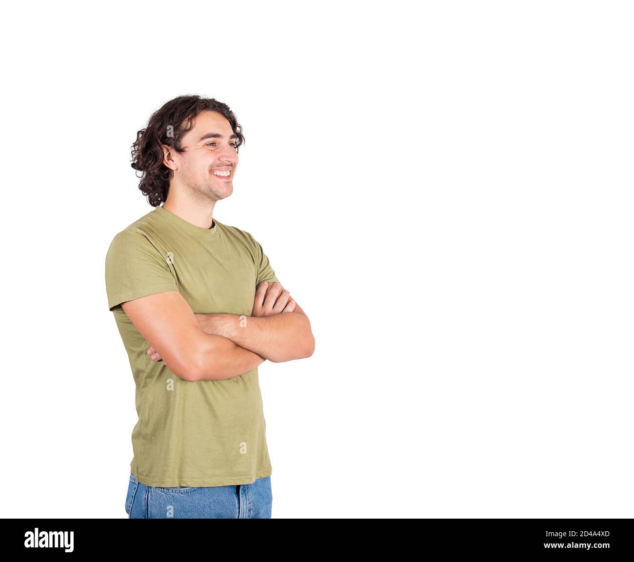 Portrait of happy brunette young man, long curly hair style, keeps arms ...
