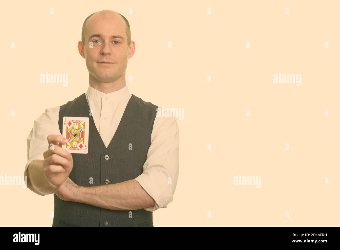 Bald Caucasian magician man holding Jack of Diamonds card Stock Photo ...