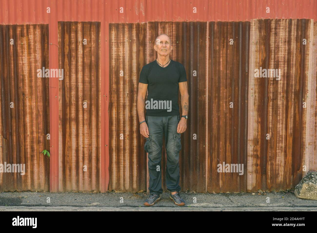 Full body shot of happy bald senior man smiling and standing against ...