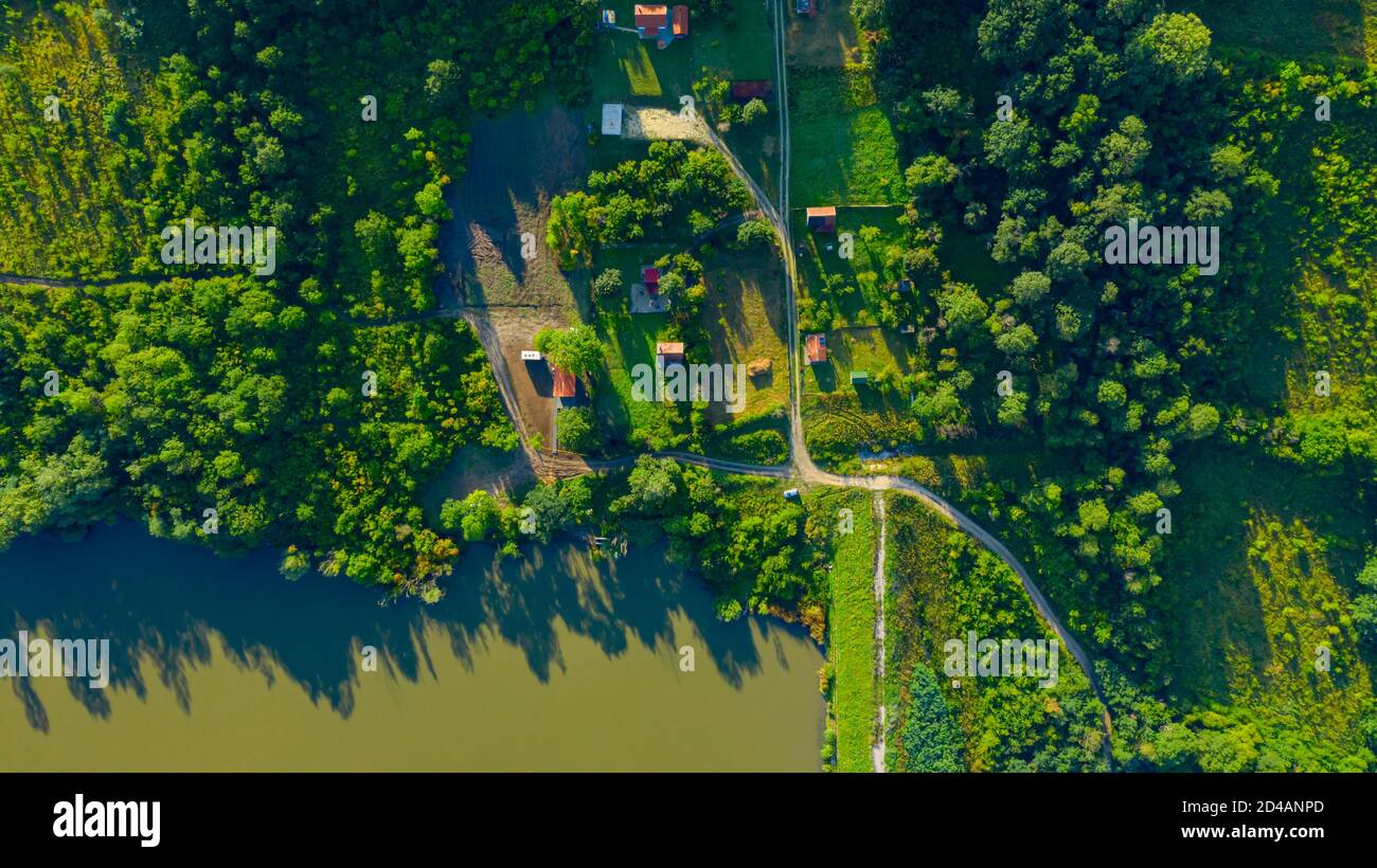 Above view over embankment, dam of lake at hilly landscape, woodland ...