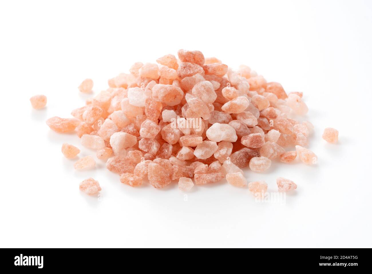 Angled shot of pink rock salt placed on white background Stock Photo ...