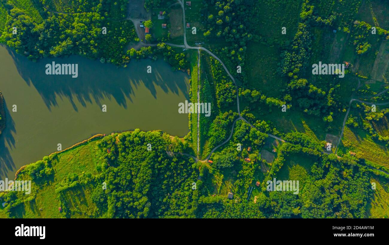 Above view over embankment, dam of lake at hilly landscape, woodland ...