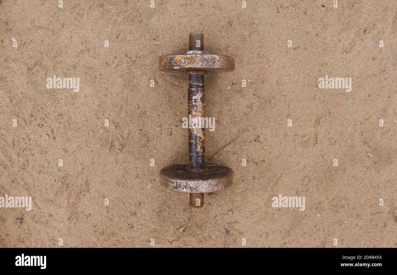 Dumbbell on the sand. handmade fitness equipment. weight lifting Stock ...