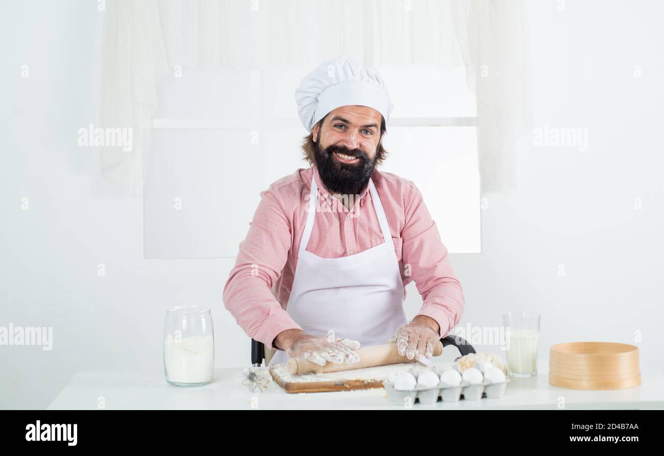 mature bearded guy wear chef hat while cooking dough in kitchen ...