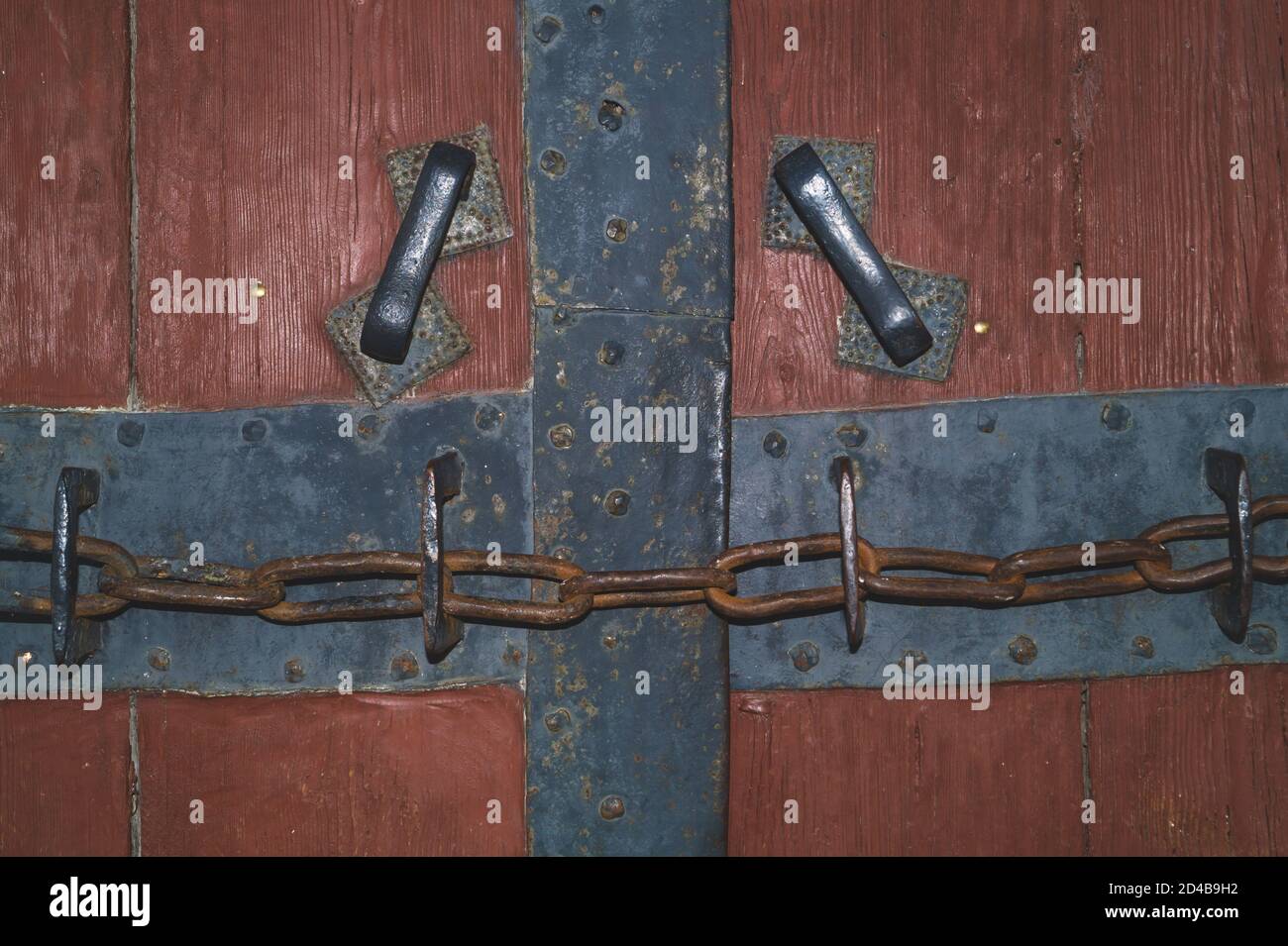 Old door locked on the chain. detail of forged iron latch. handwork ...