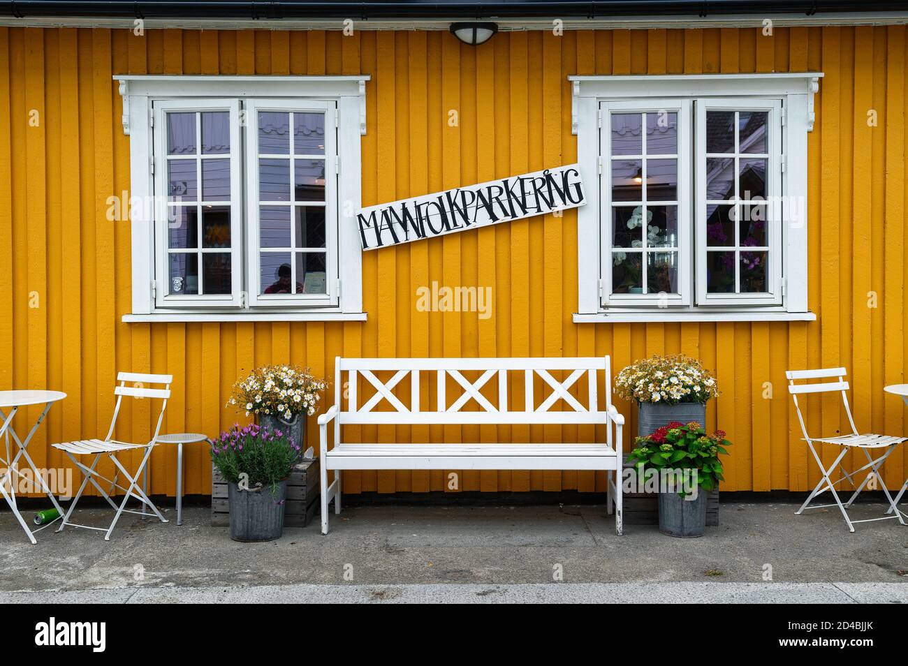 Typical norwegian facade with a bench and flowers in Lofoten Islands ...