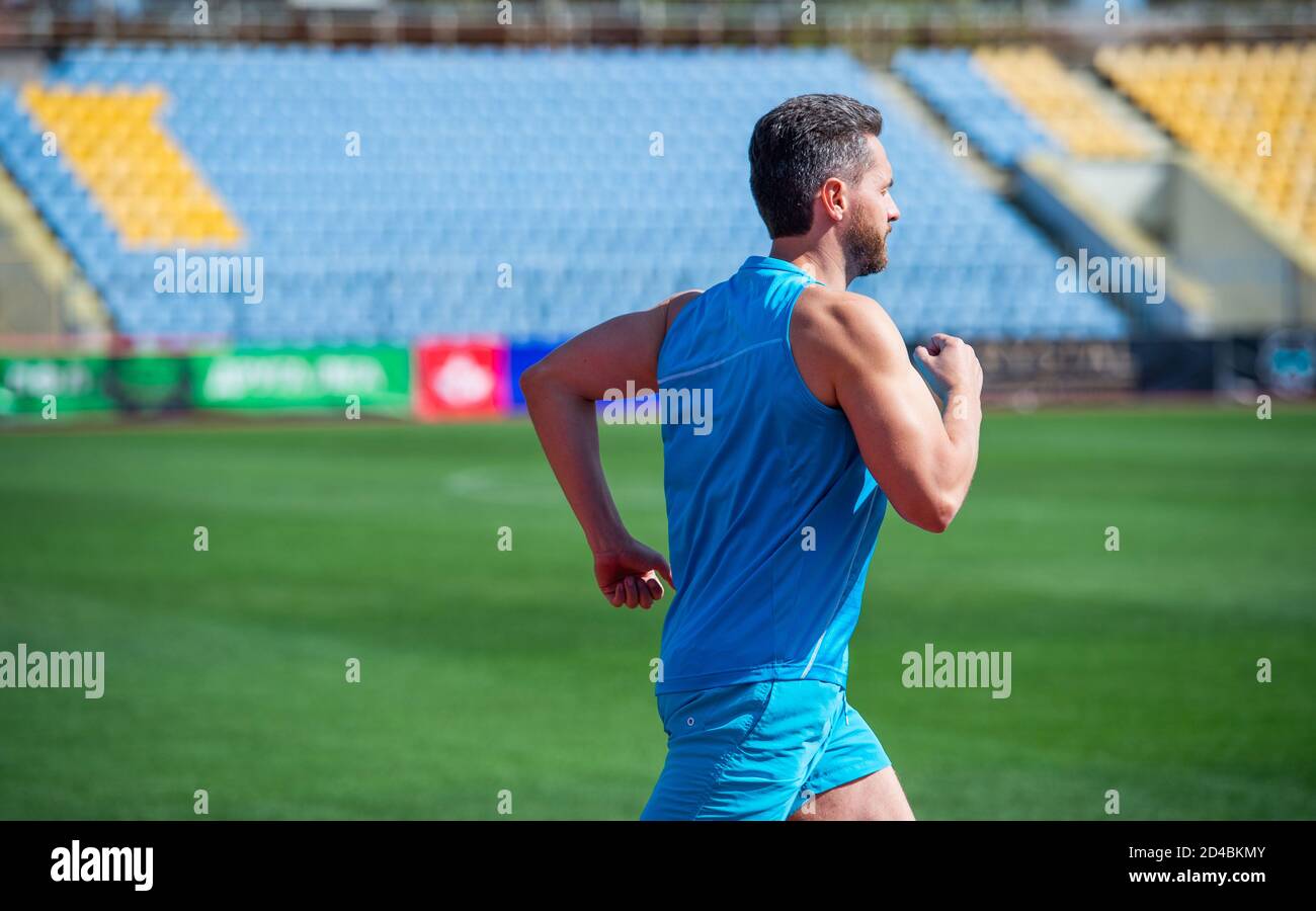 man running on stadium. fitness gym outdoor. muscular athletic runner ...