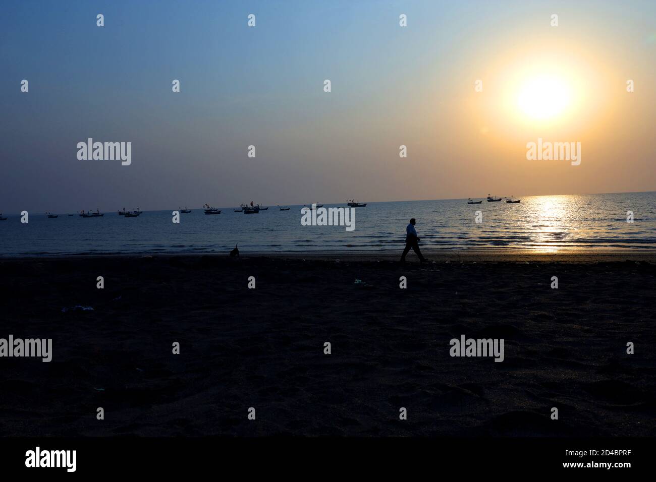 The sunset at a lovely beach crowded by peoples Stock Photo - Alamy