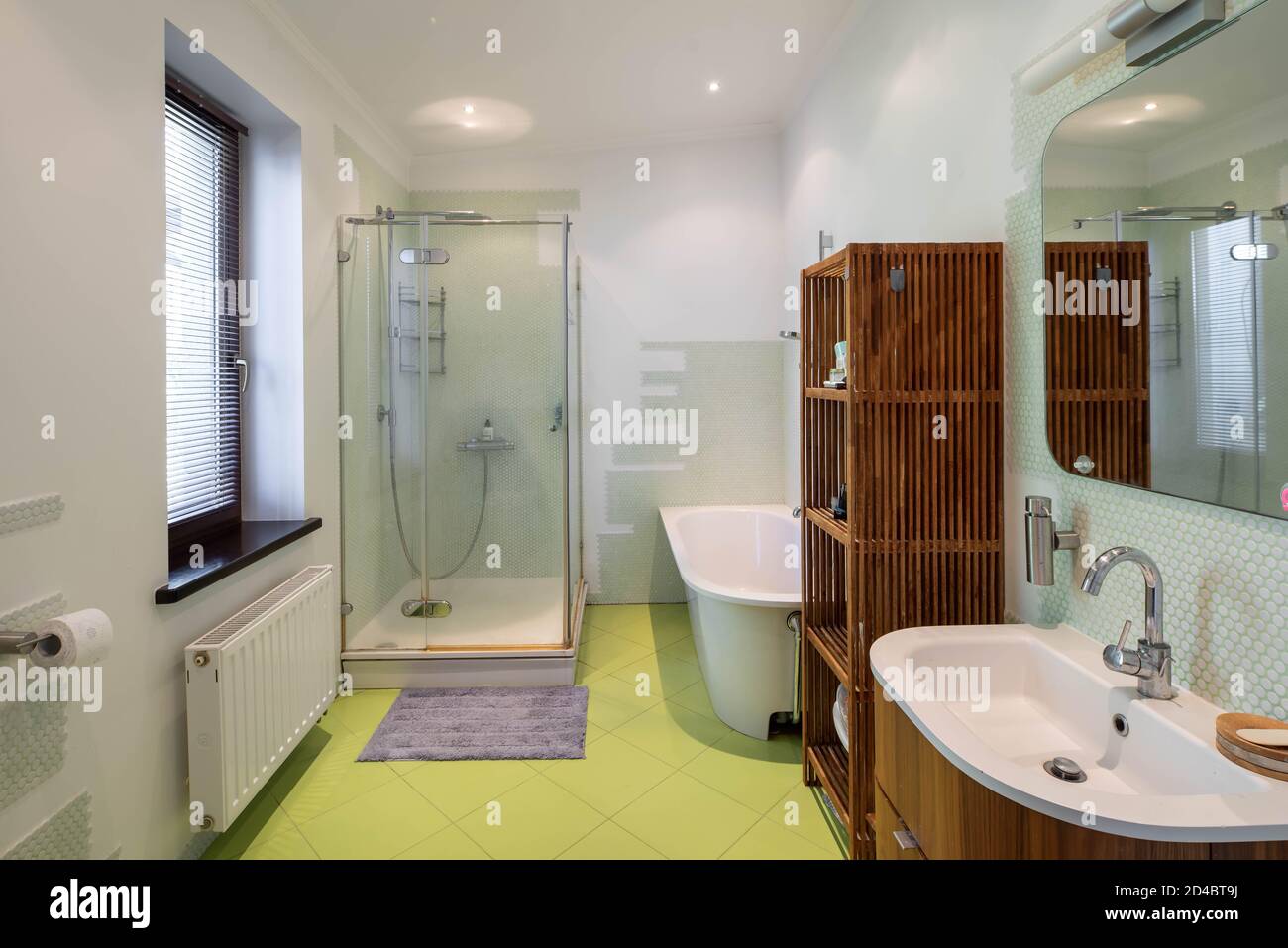 Modern interior of spacious bathroom. Shower cabin. White bath. Wooden shelf. Sink and mirror ...