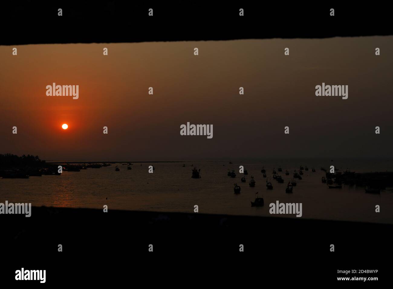 The sunset at a lovely beach crowded by peoples Stock Photo - Alamy