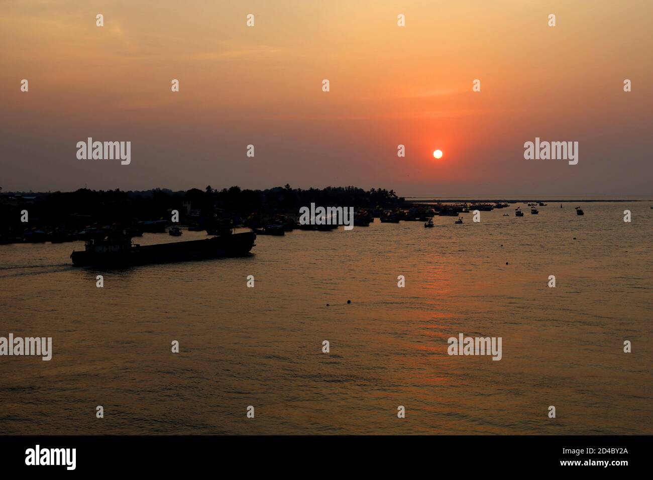 The sunset at a lovely beach crowded by peoples Stock Photo - Alamy