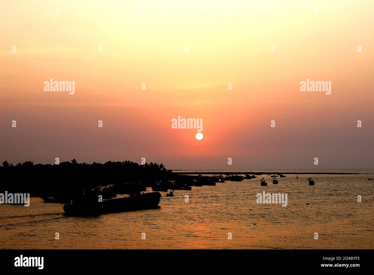 The sunset at a lovely beach crowded by peoples Stock Photo - Alamy